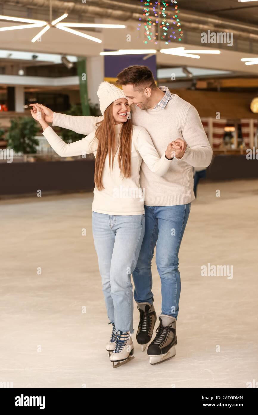 Happy couple on skating rink Stock Photo - Alamy