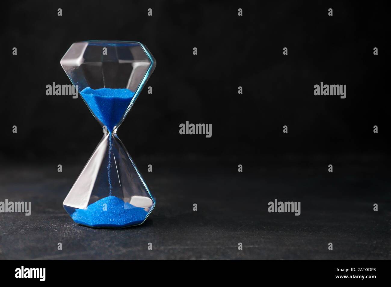 Hourglass on dark background. Time management concept Stock Photo - Alamy