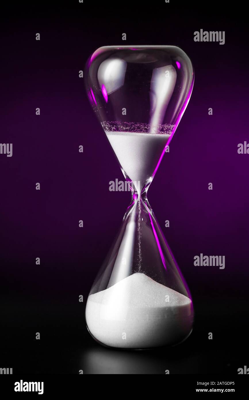 Hourglass on dark background. Time management concept Stock Photo - Alamy