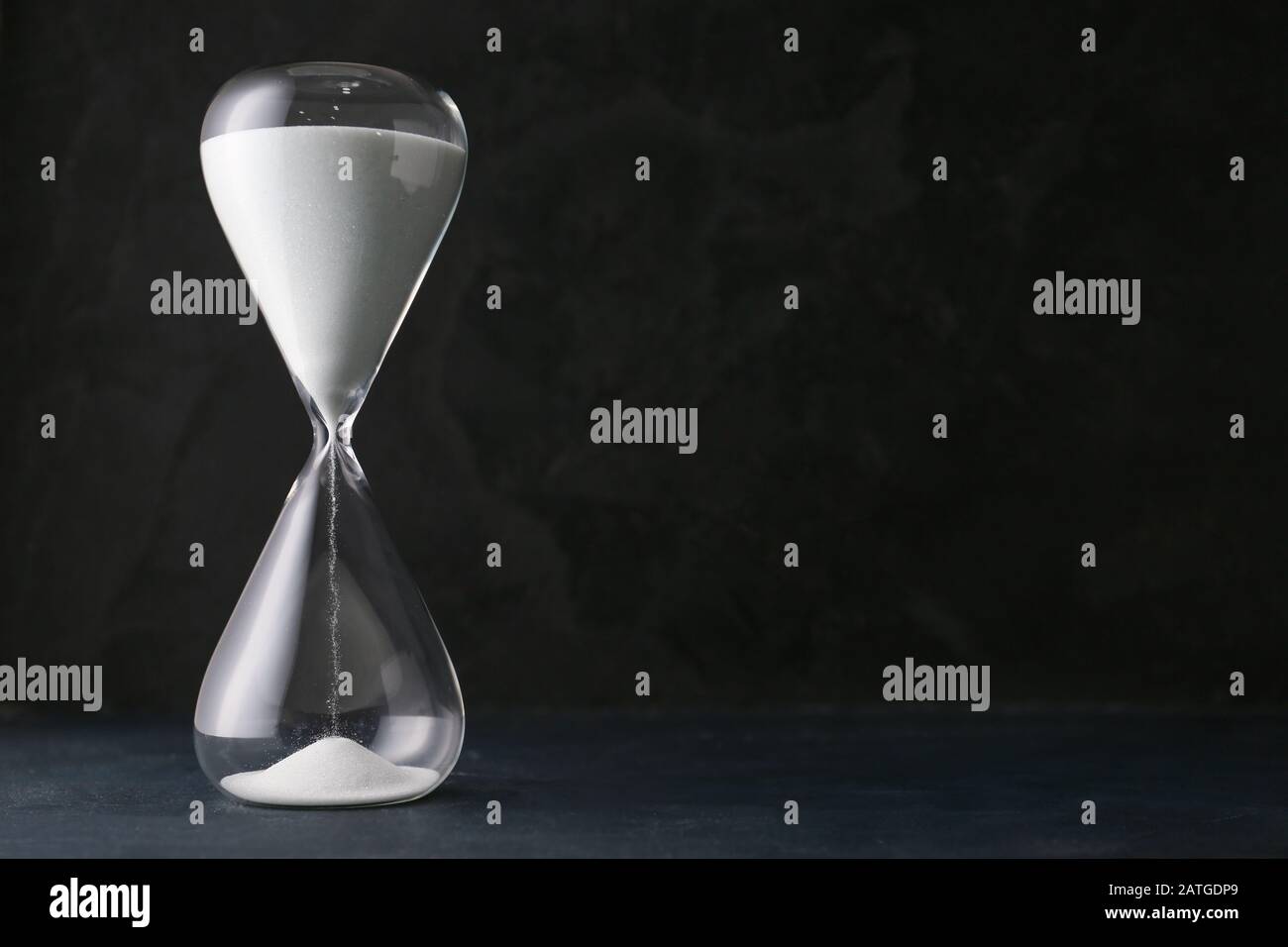 Hourglass on dark background. Time management concept Stock Photo - Alamy
