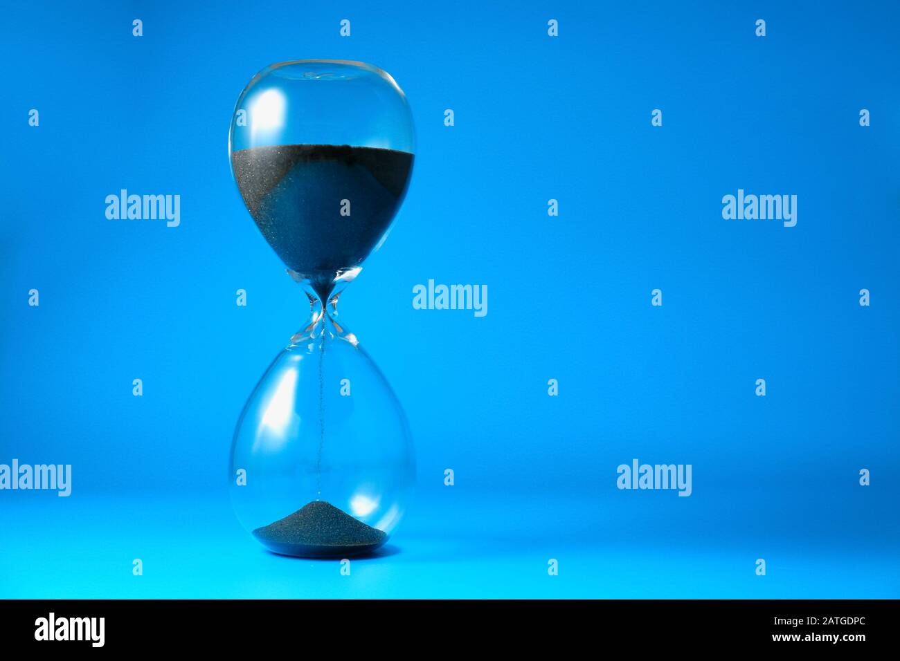 Hourglass on color background. Time management concept Stock Photo - Alamy