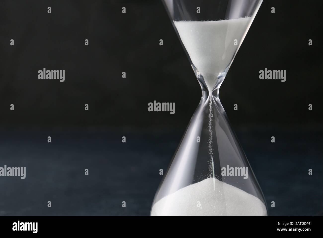 Hourglass on dark background. Time management concept Stock Photo - Alamy