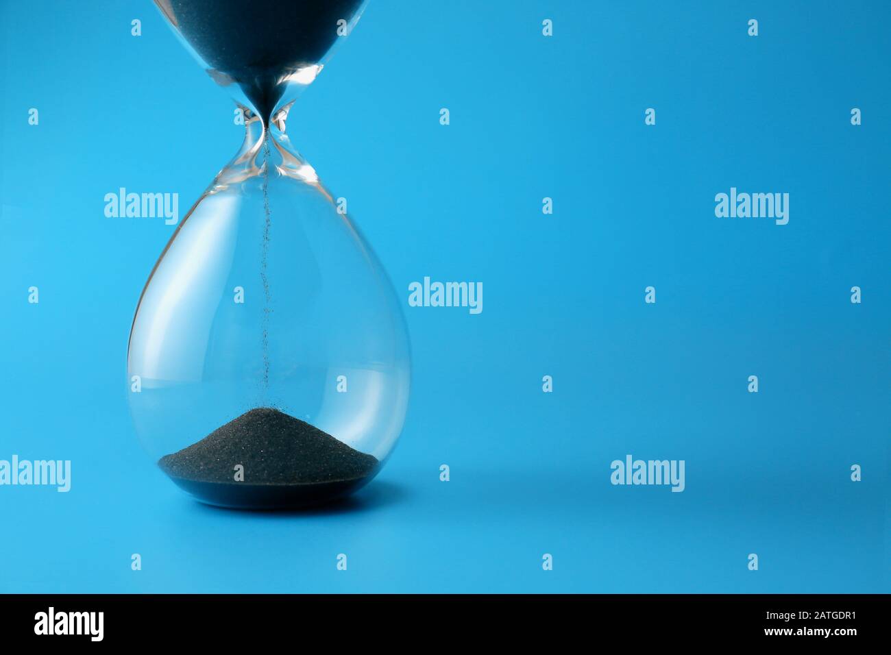 Hourglass on color background. Time management concept Stock Photo - Alamy