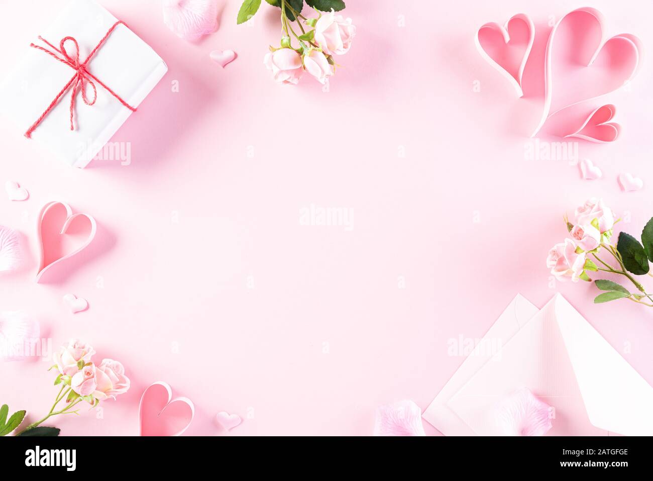 Pink paper hearts with gift box and roses on Light pink pastel paper ...