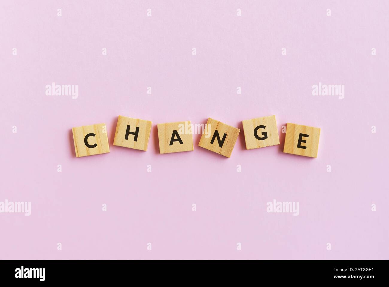 Change text wood blocks. Pink background Stock Photo - Alamy
