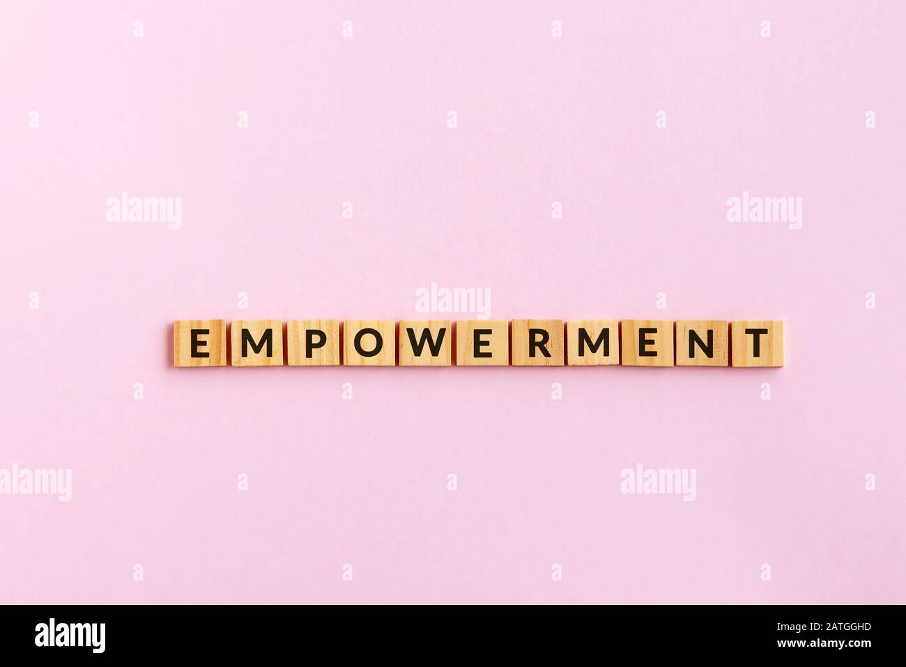 Empowerment text wood blocks. Pink background Stock Photo - Alamy