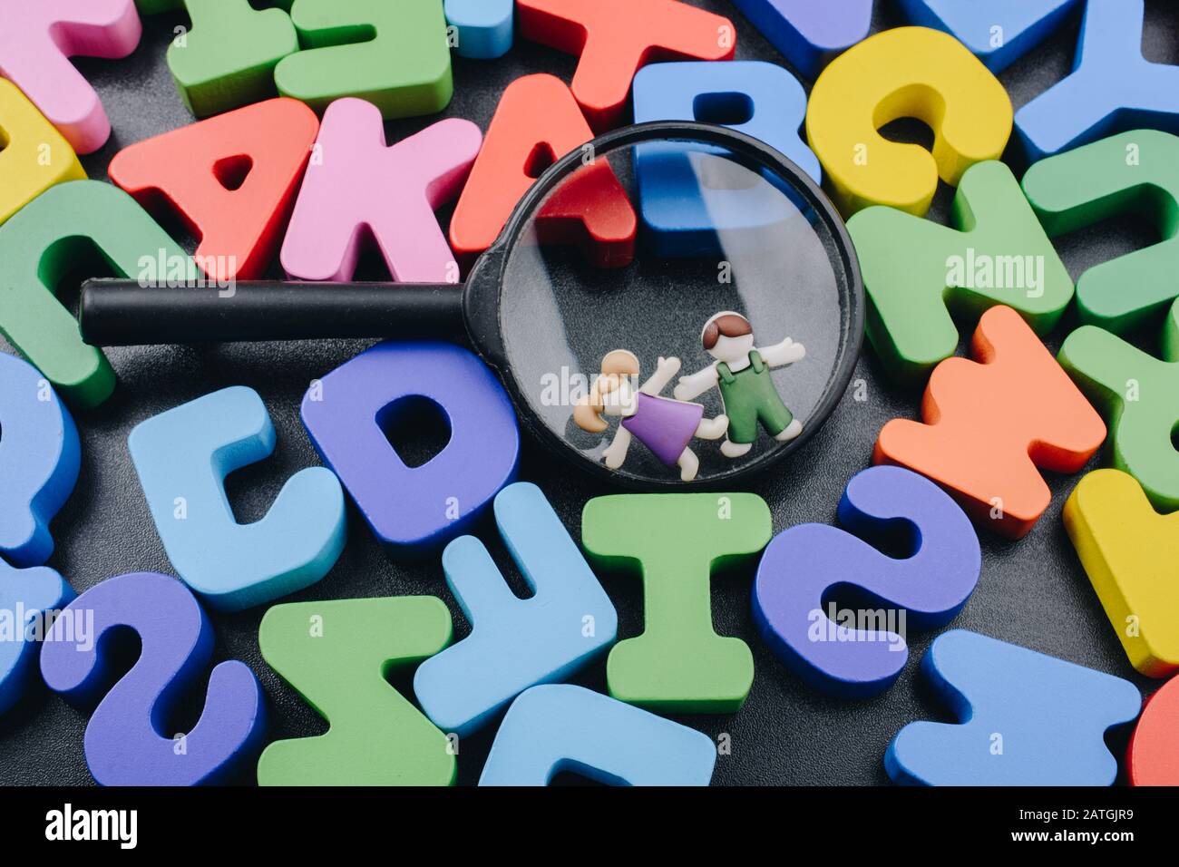 Kids over Magnifying glass and Colorful Letters of Alphabet Stock Photo ...