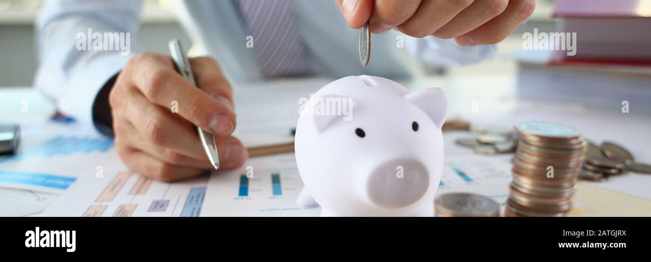 Hand businessman putting pin money Stock Photo - Alamy