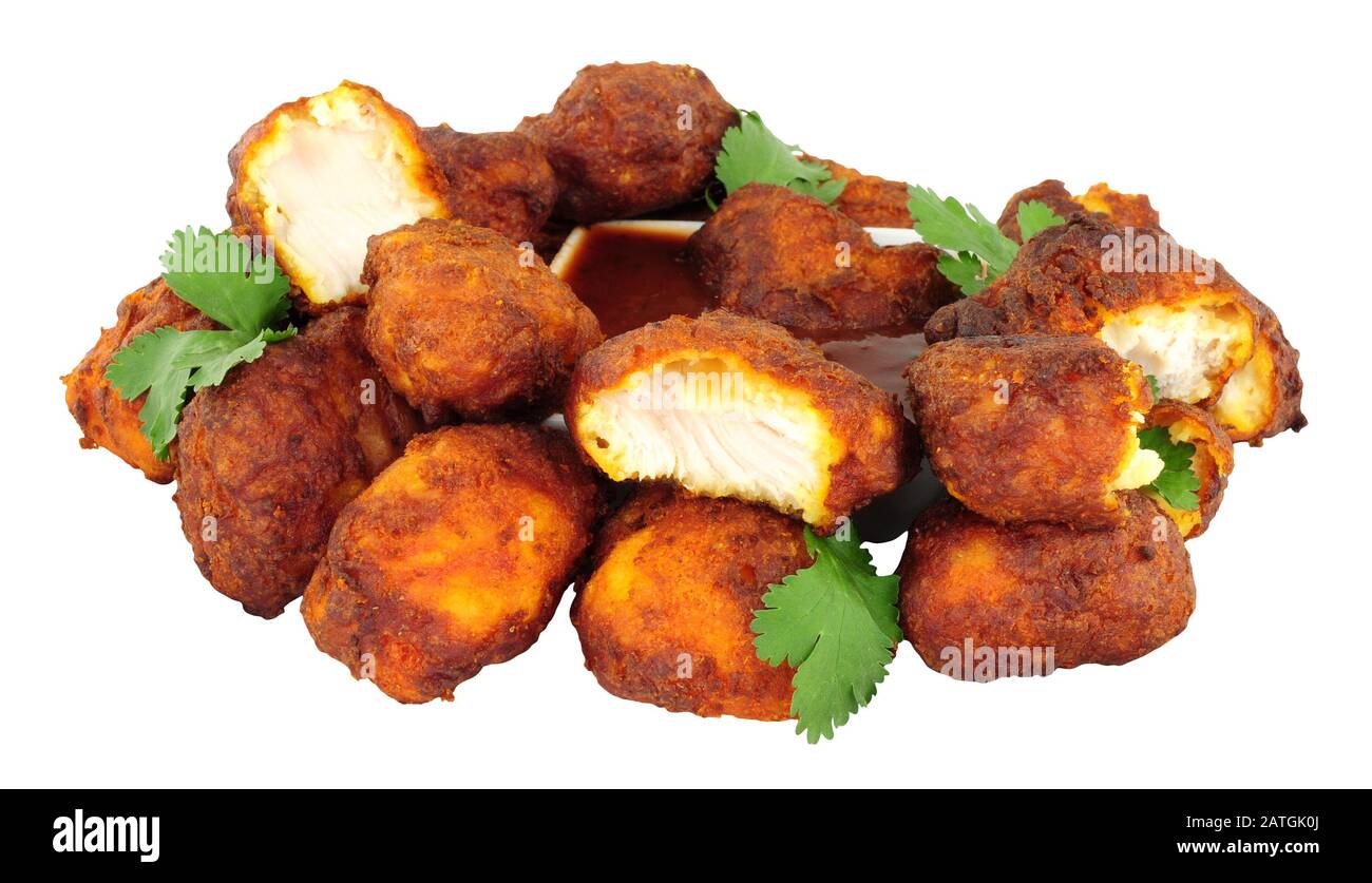 Group of fried chicken pakora with chilli sauce dip isolated on a white ...