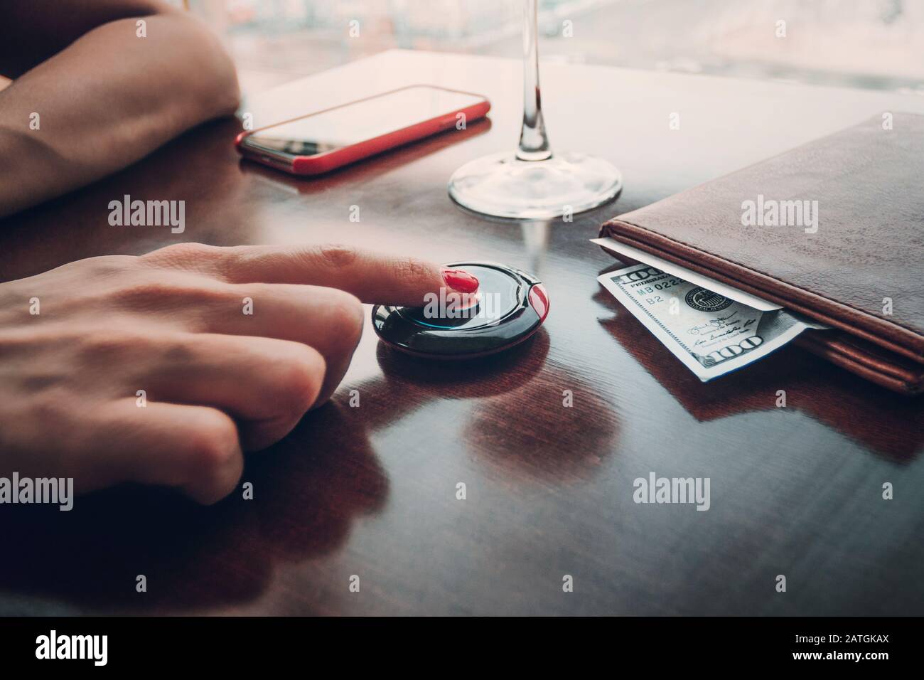 Close-up Of Woman's Hand Ringing Service Bell,Buzzer in the restaurant ...