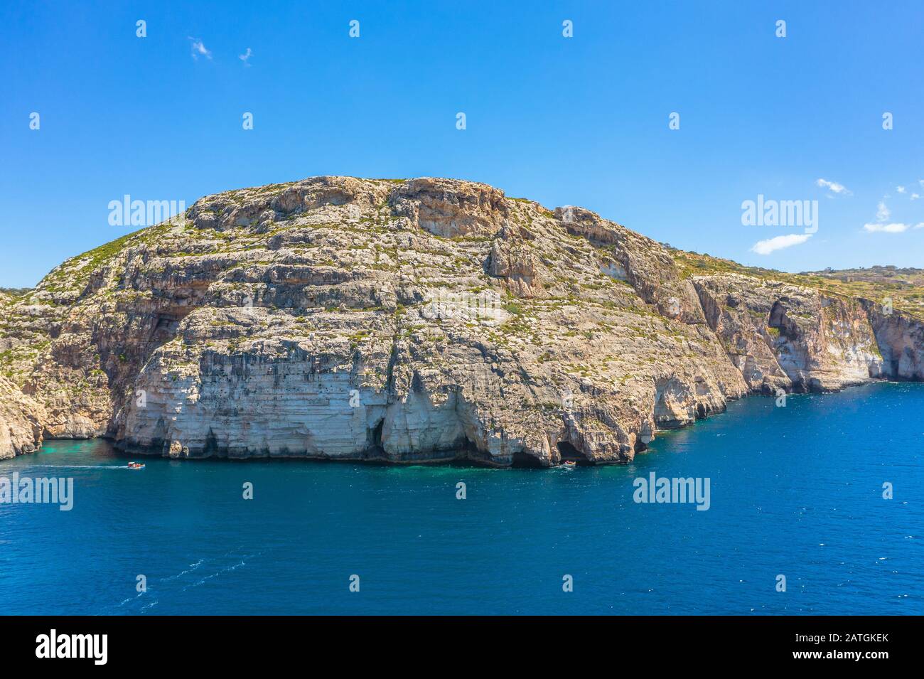 Big high rock island in the blue sea Stock Photo - Alamy
