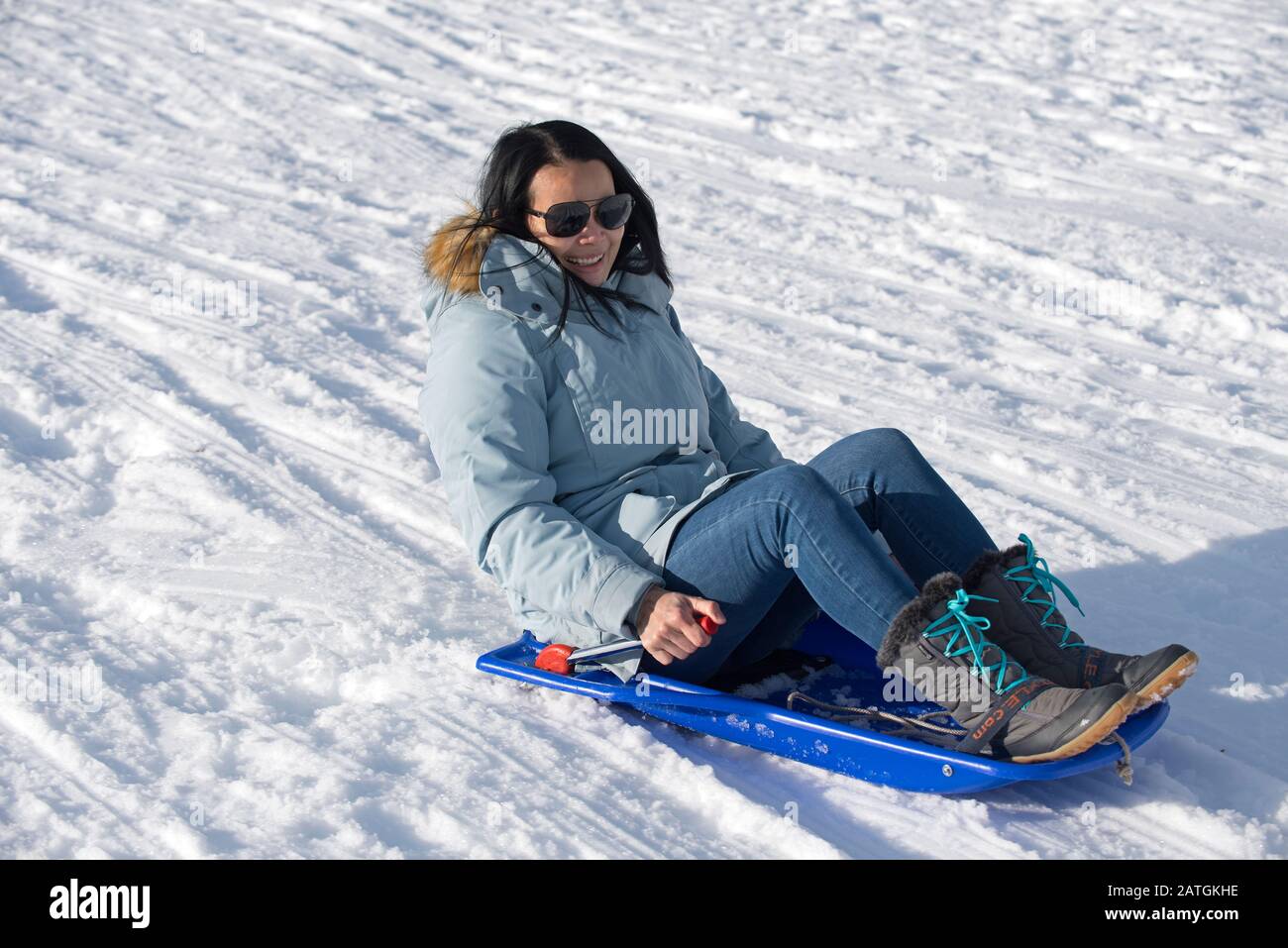 Woman on a sledge Stock Photo - Alamy
