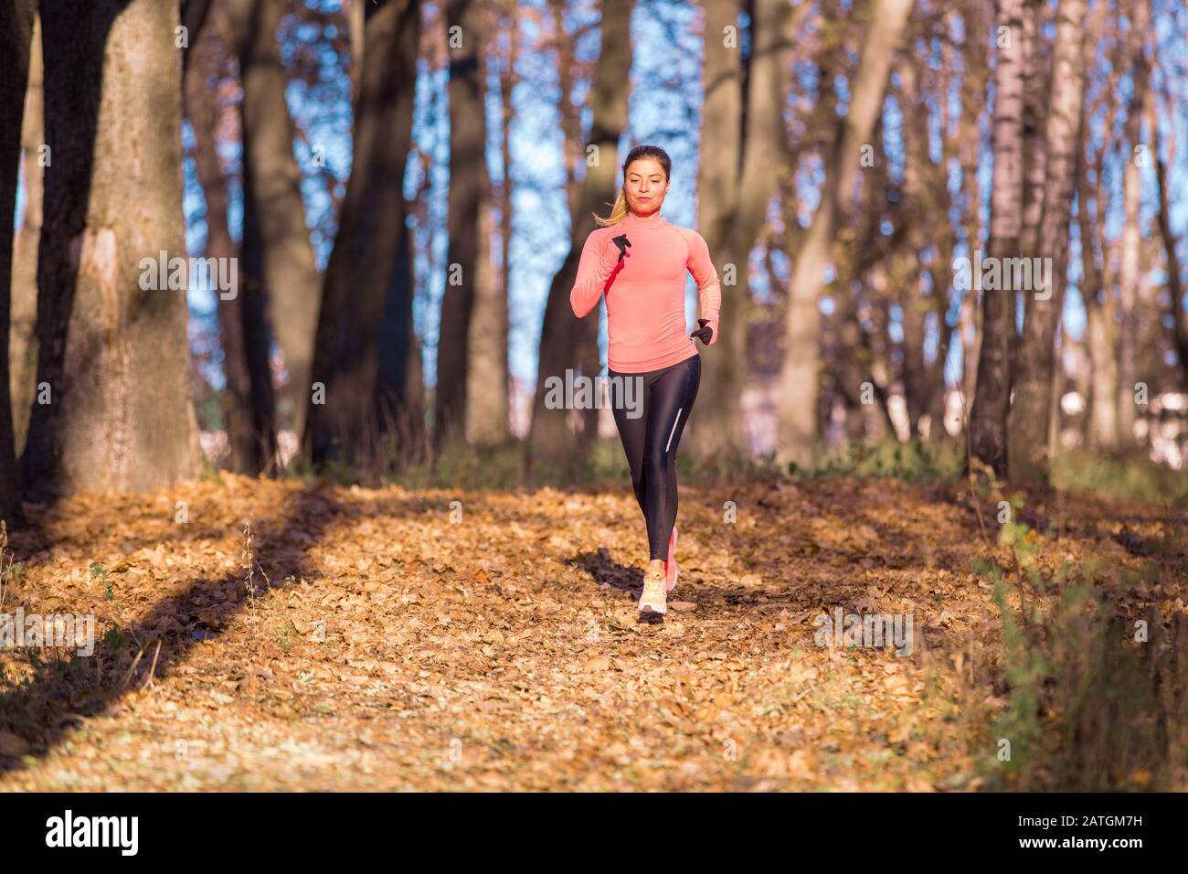 Fitness girl training running in the morning park. Sporty woman jogging ...