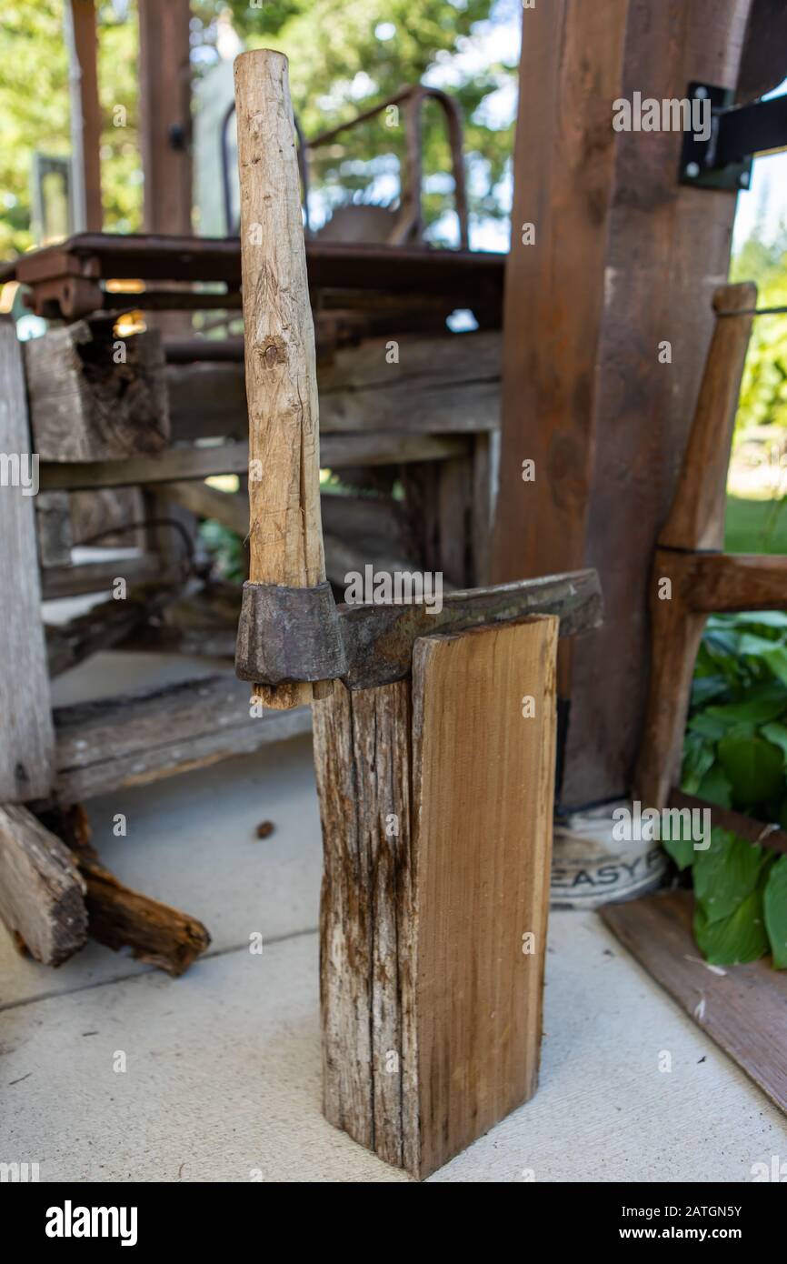 Vintage ax stuck in wood casting. An old rustic ax used for chopping ...