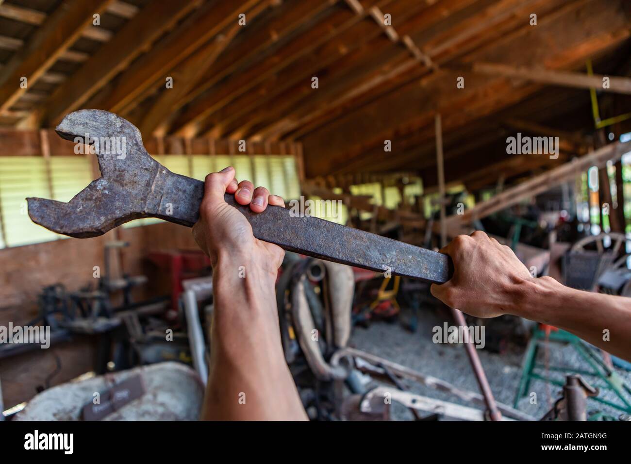 Unrecognizable male holding an old giant wrench. Large antique wrench ...