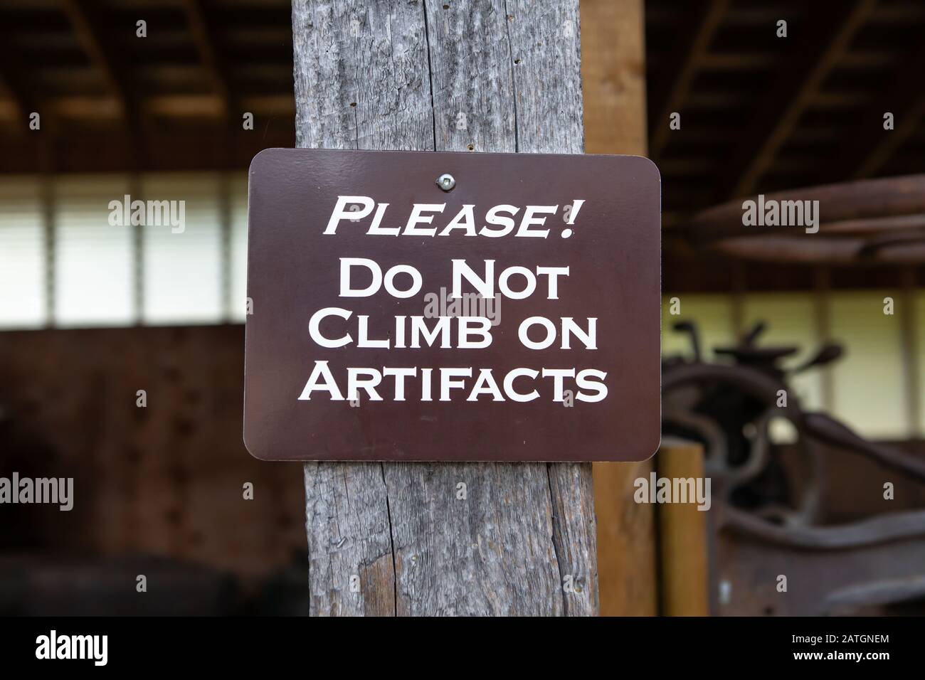 Signboard with caution message. Do not climb on artifacts. A wooden ...