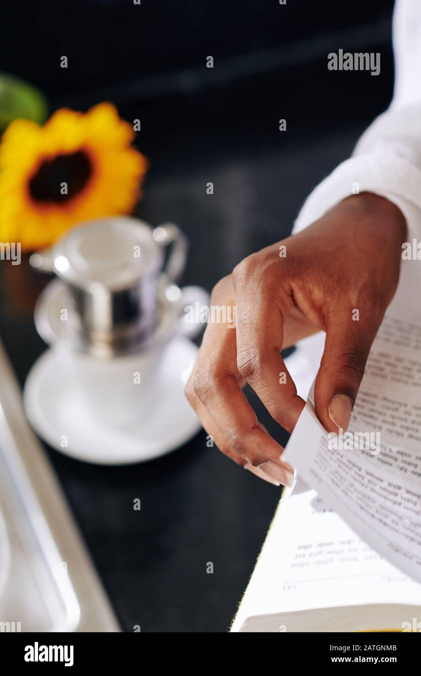 Hand turning page book hi-res stock photography and images - Alamy