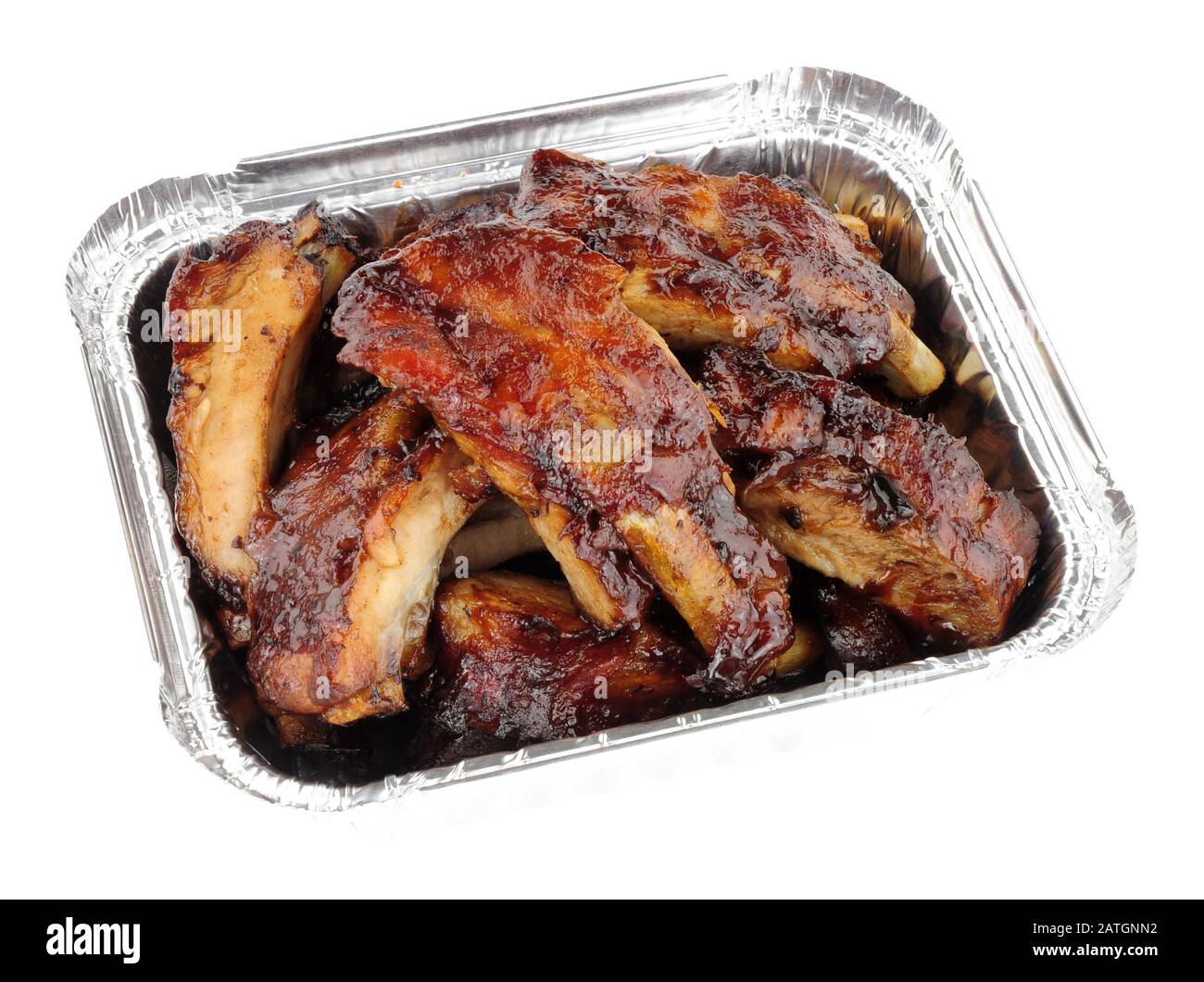 Hoisin sauce Chinese pork ribs in a foil take away tray isolated on a ...