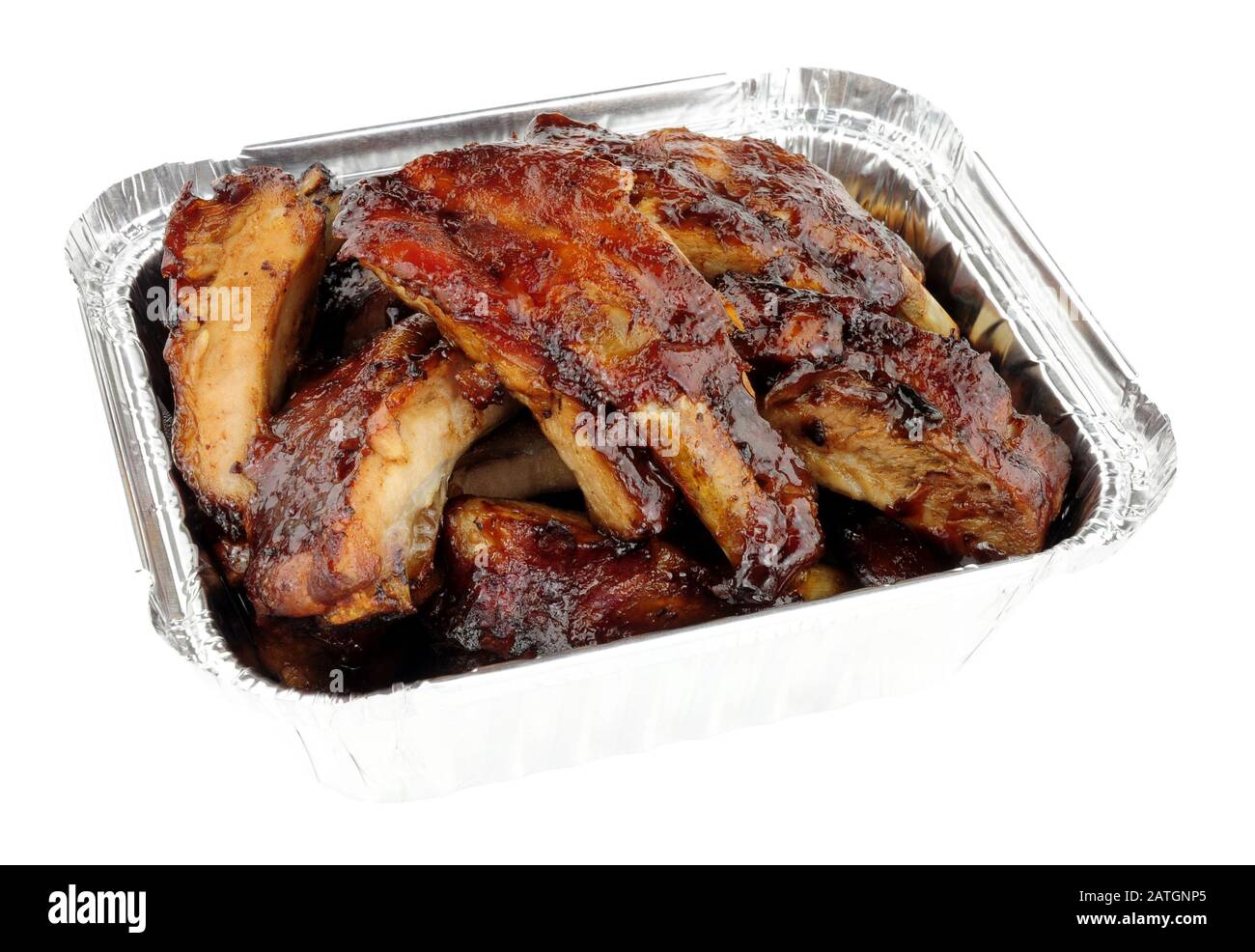 Hoisin sauce Chinese pork ribs in a foil take away tray isolated on a ...