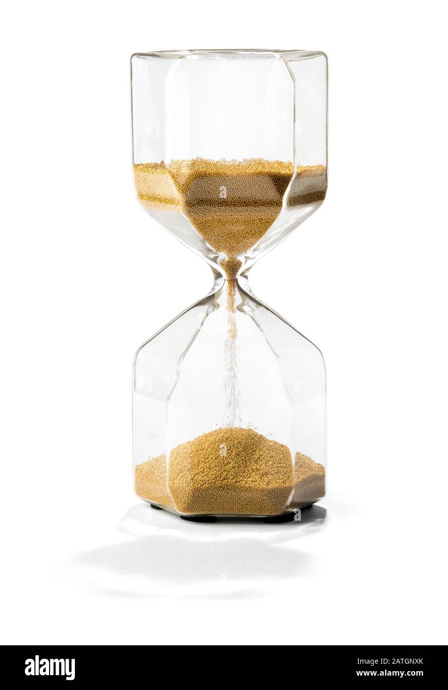 Sand running through an hourglass with shadow measuring passing time ...