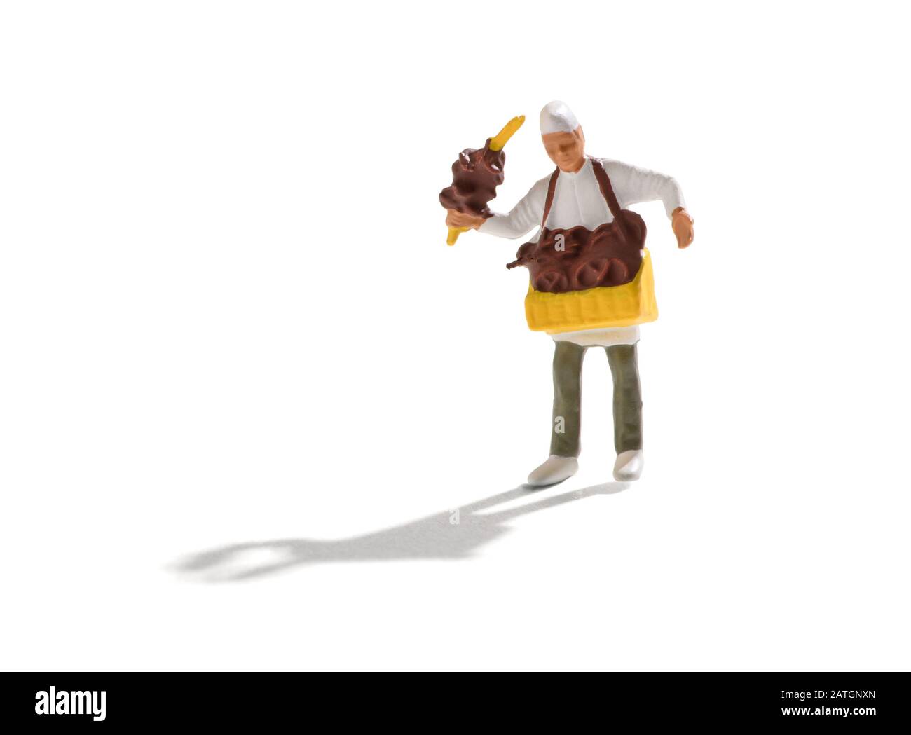 Miniature pretzel seller in white bakers cap and uniform with tray of ...