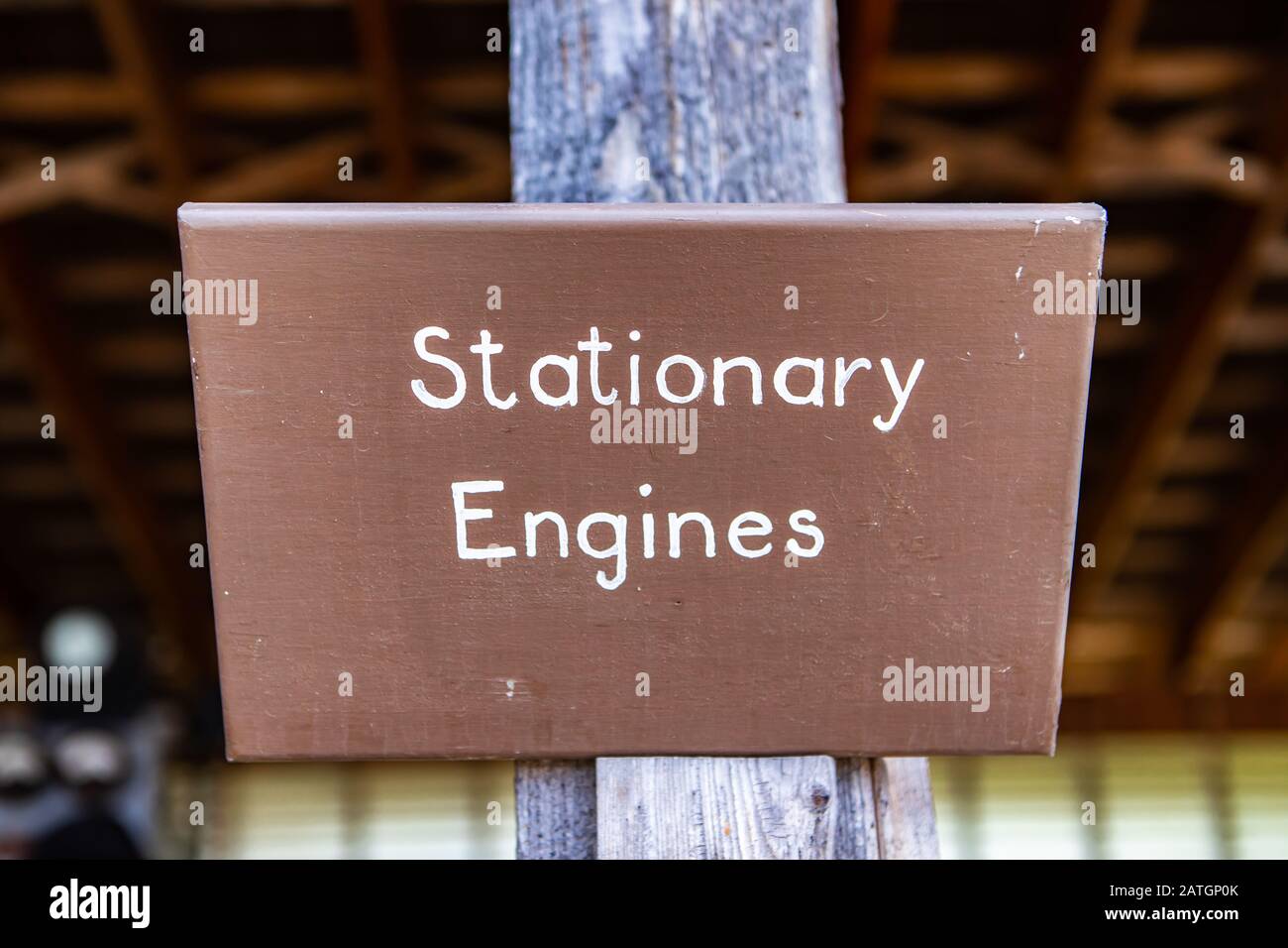 A signboard with text - stationary engines hanged on the wooden pillar ...