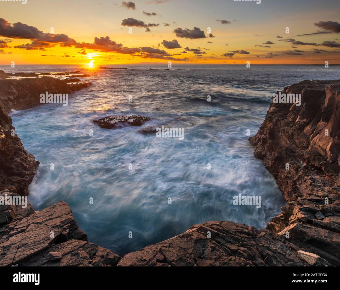 beautiful and dramatic sunset on a craggy rocky cliff, Jandia Peninsula ...
