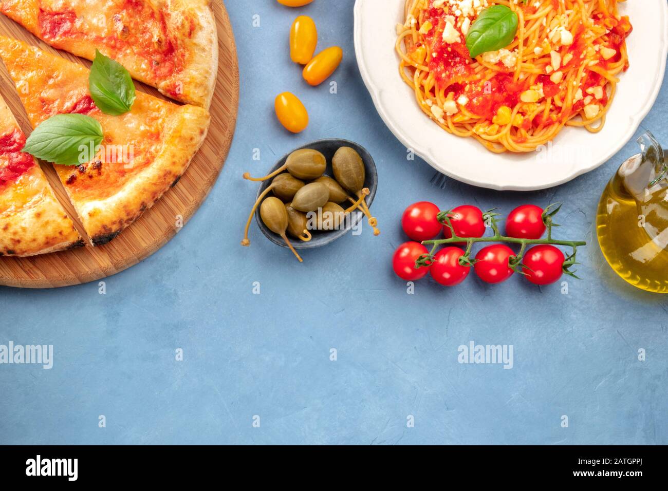 Italian food background. Pizza, pasta, tomatoes, capers etc, shot from ...