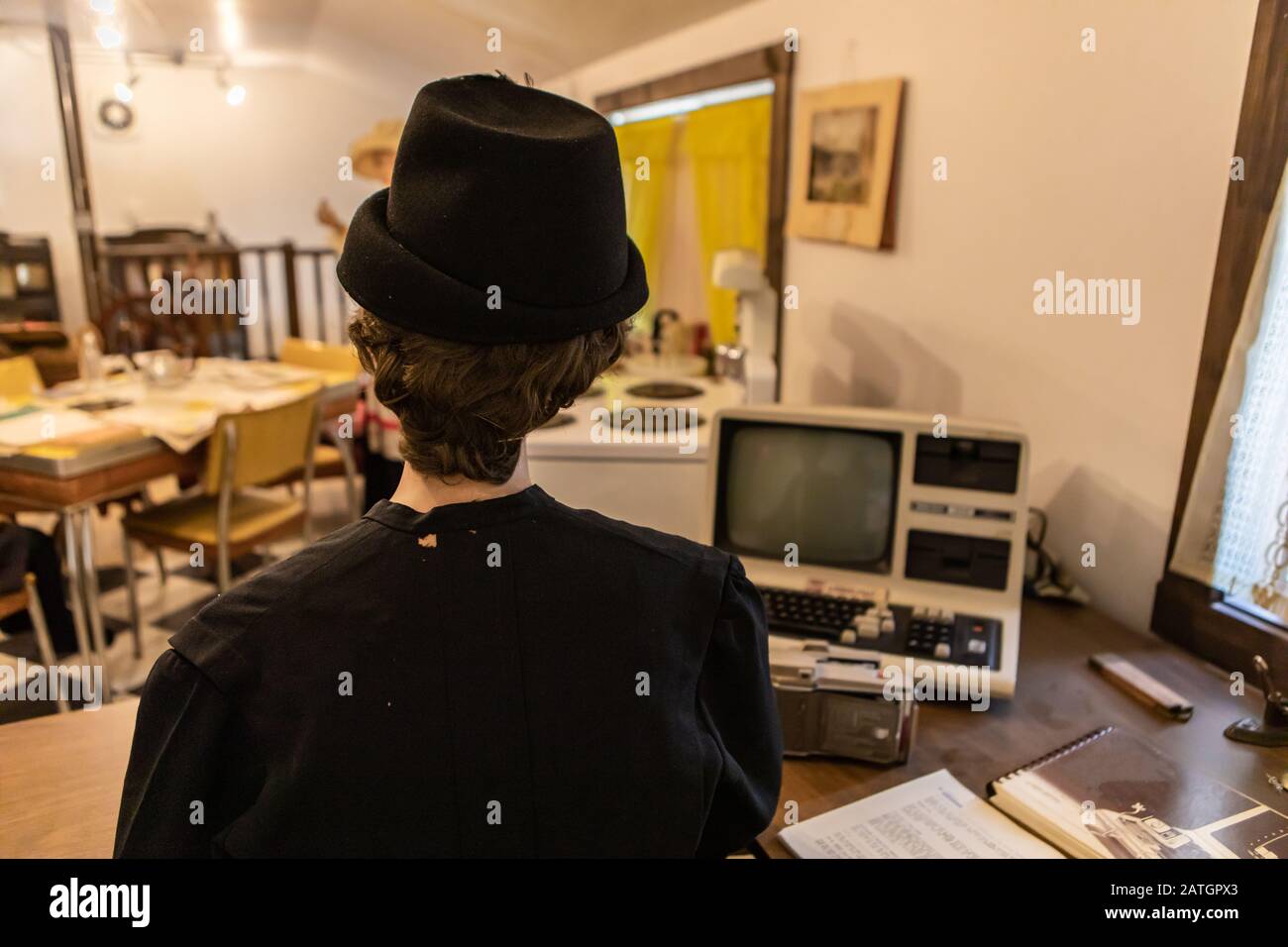Typical office workspace in the 1980s with first vintage PC. Female ...