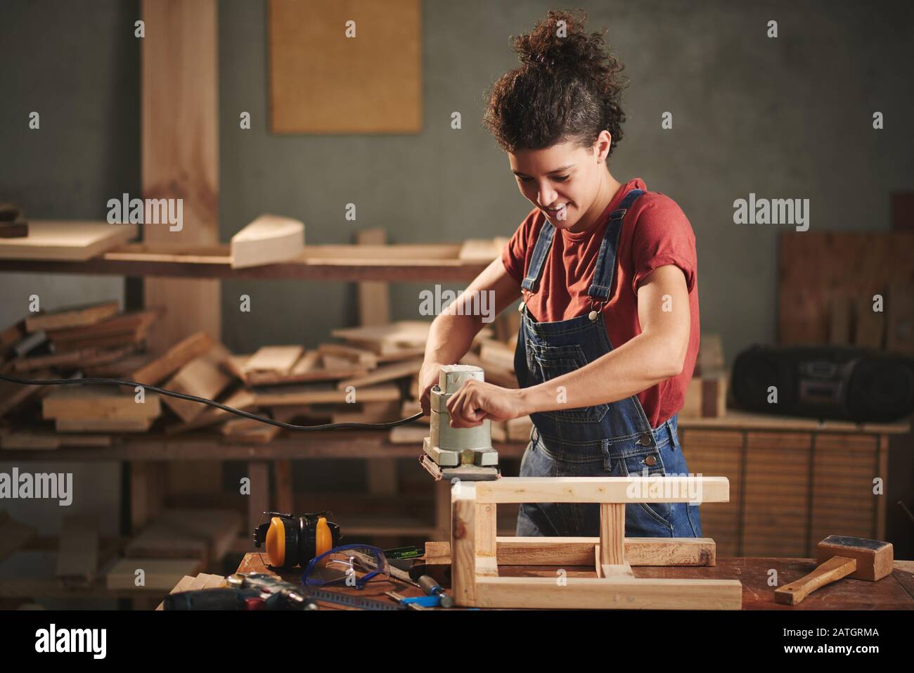 Female carpenter smoothing wooden hi-res stock photography and images ...