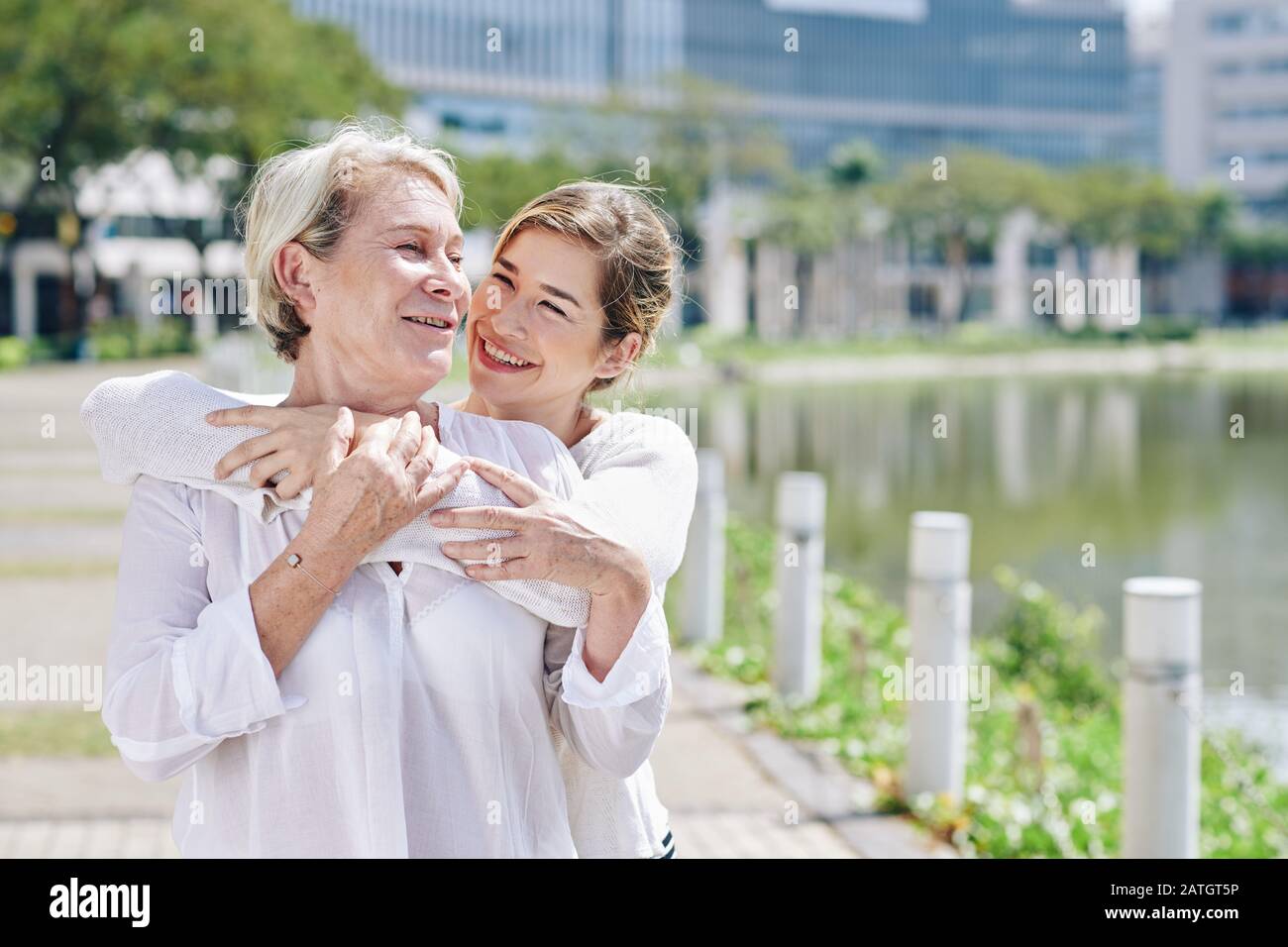 Couple hugging from behind laughing hi-res stock photography and images ...