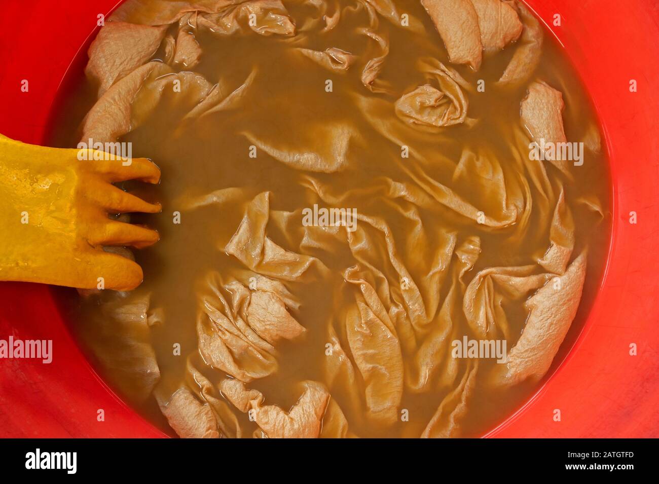 Soaking cloth in Dye process for saree printing Stock Photo - Alamy