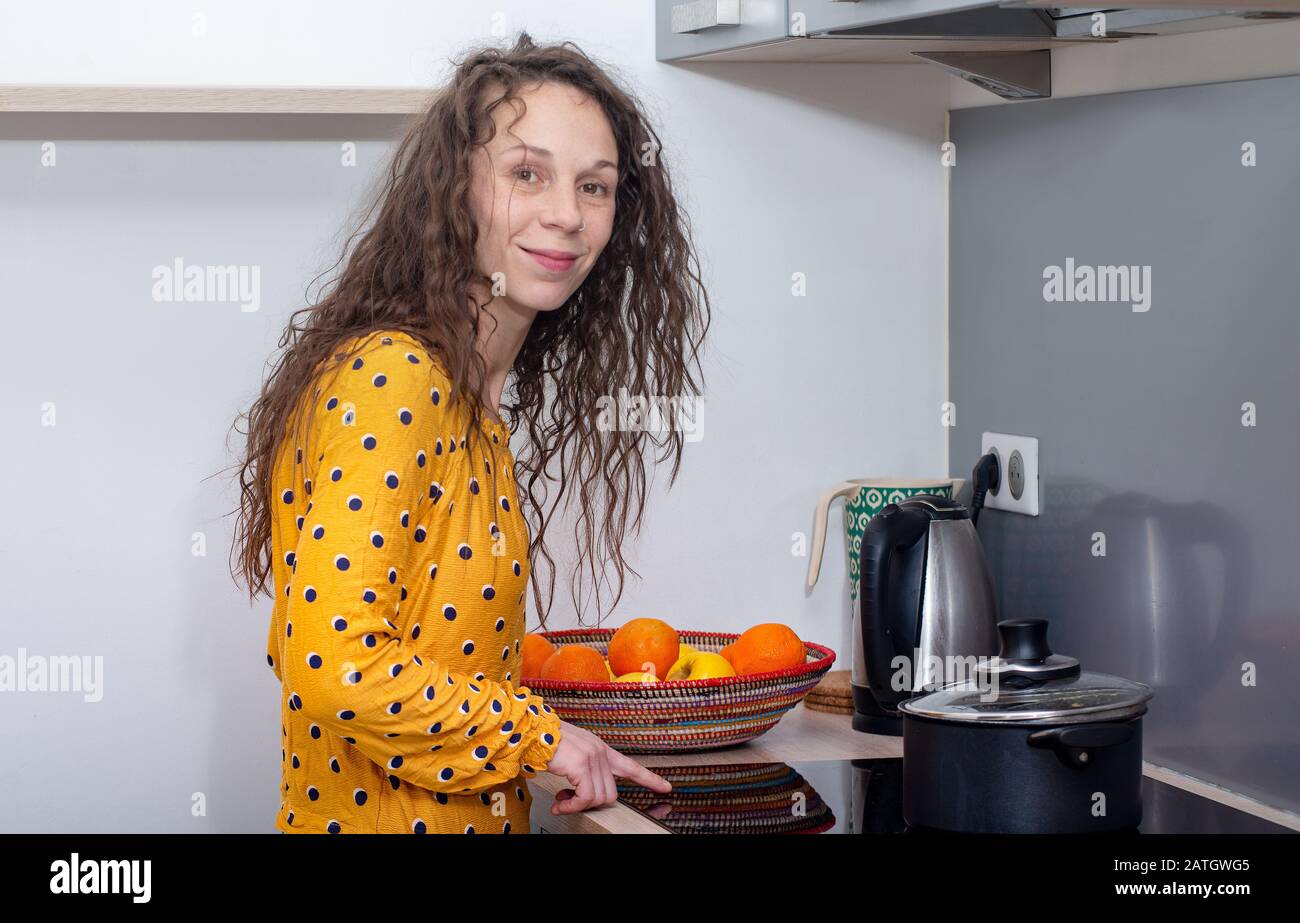 a young woman with long hair is in the kitchen Stock Photo - Alamy