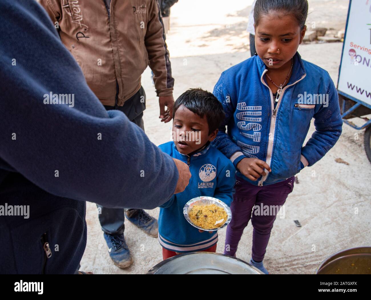 Free distribution of food at a food camp in New Delhi for poor people ...