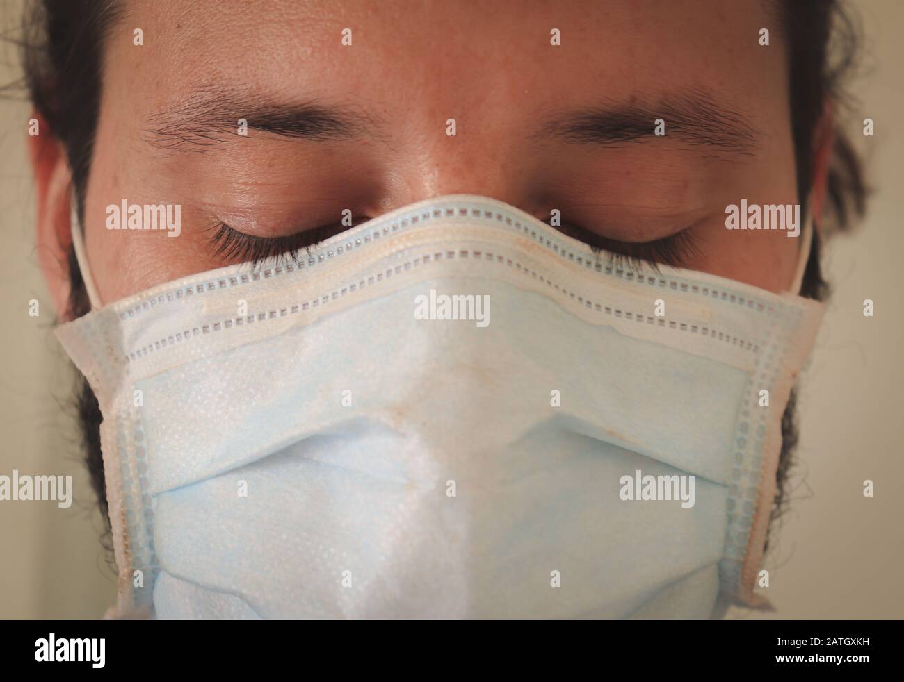 Caucasian man wearing a surgical mask to promote social distancing and ...