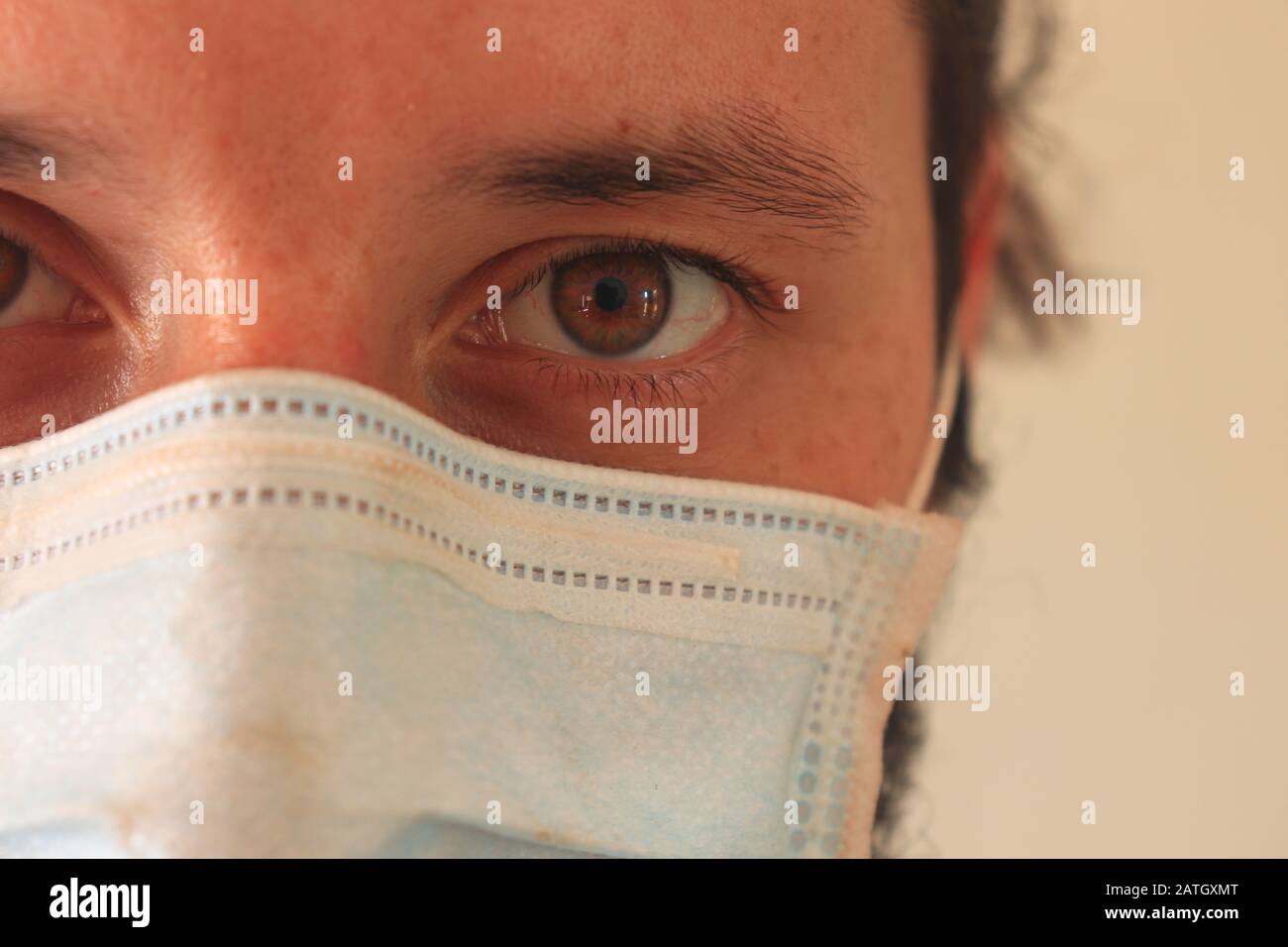 Caucasian man wearing a surgical mask to promote social distancing and ...