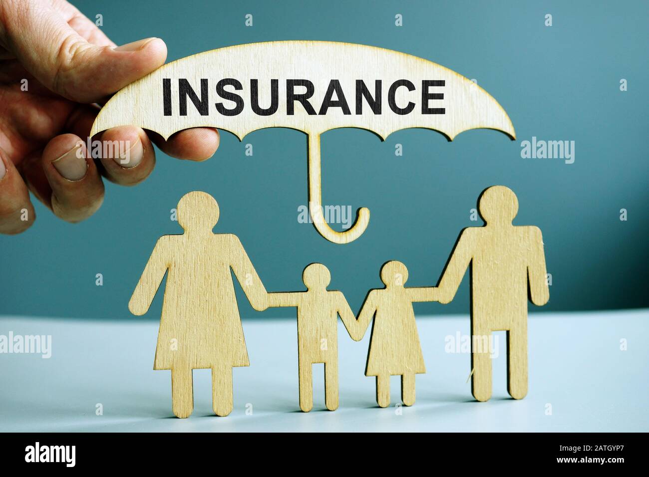 Life insurance concept. Figures of family and umbrella Stock Photo - Alamy