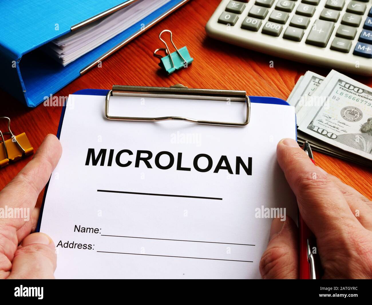 Microloan application form with money for lending Stock Photo - Alamy