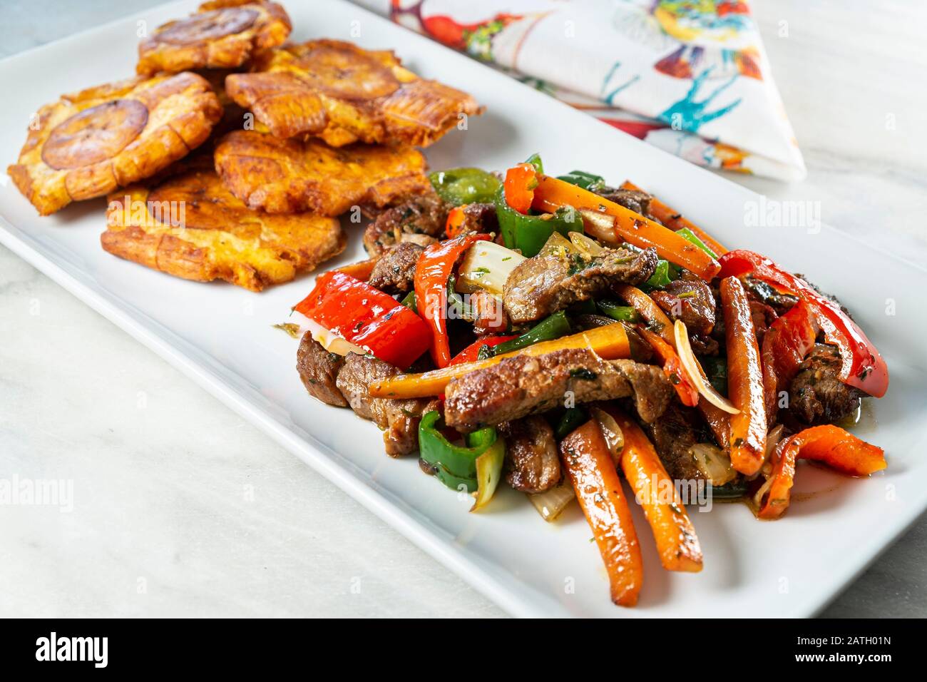 Chopped steak or Bistec Picao and patacones or tostones are fried green ...