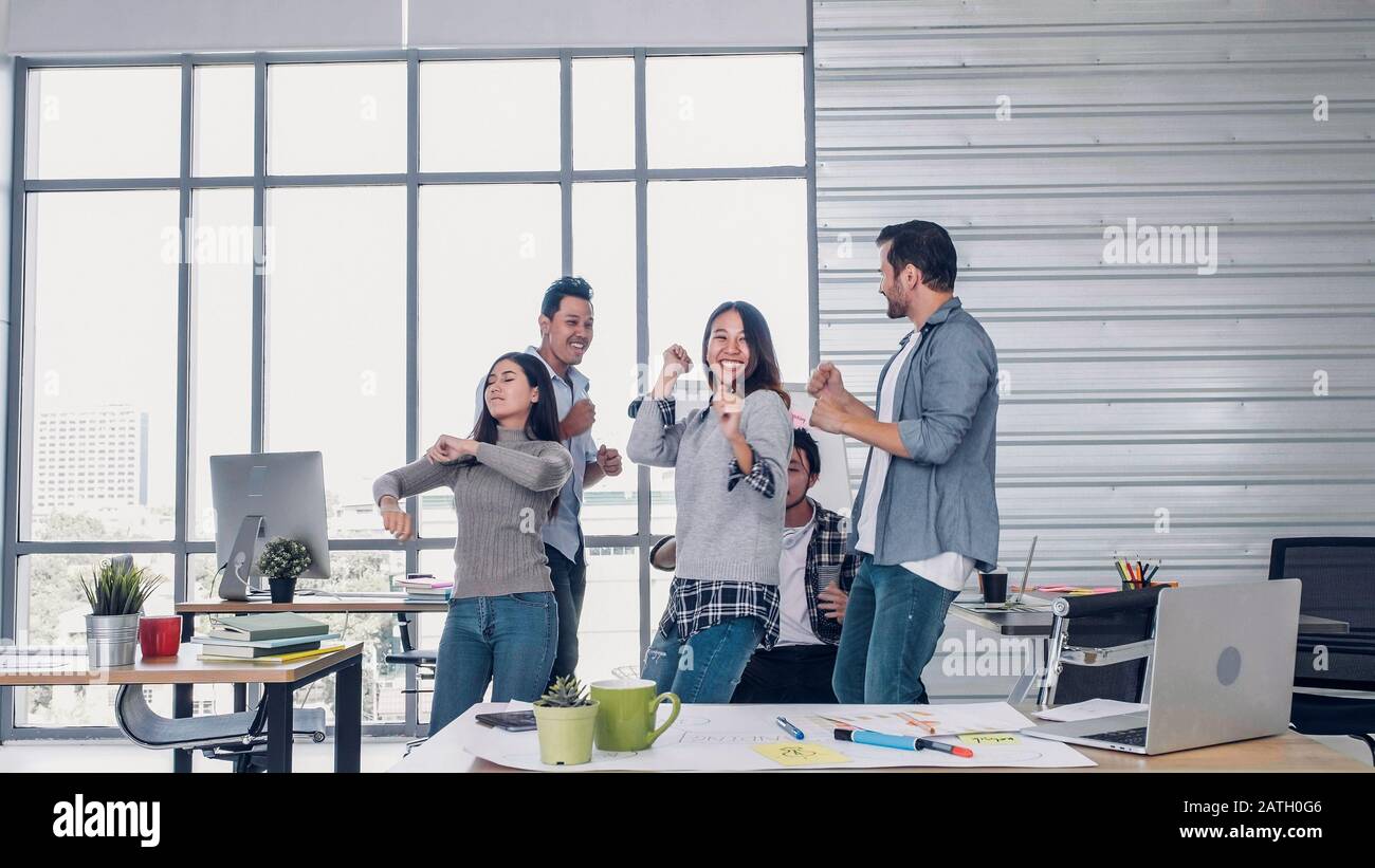 Happy colleagues dancing in office hi-res stock photography and images ...