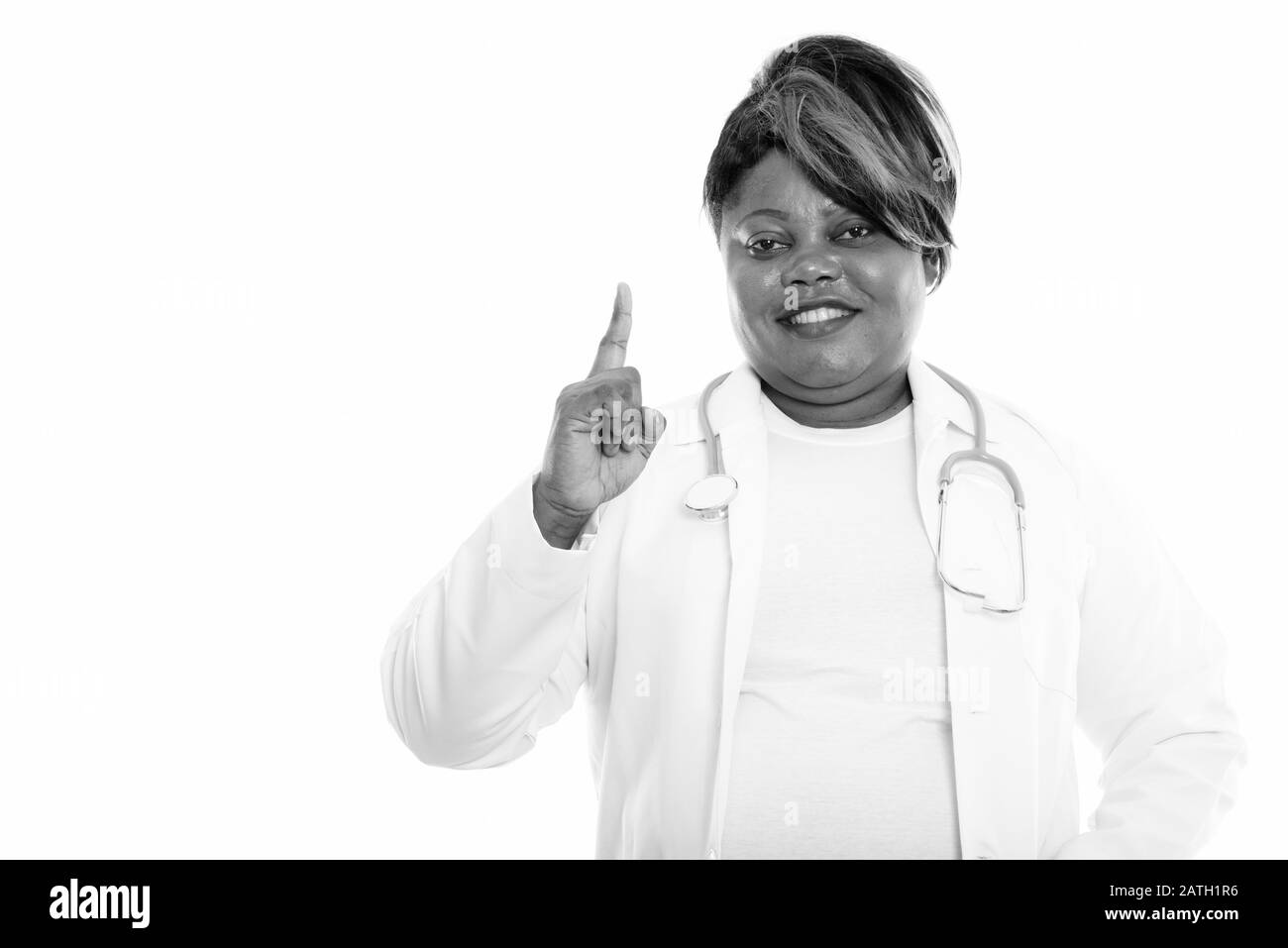 Studio shot of happy fat black African woman doctor smiling while ...
