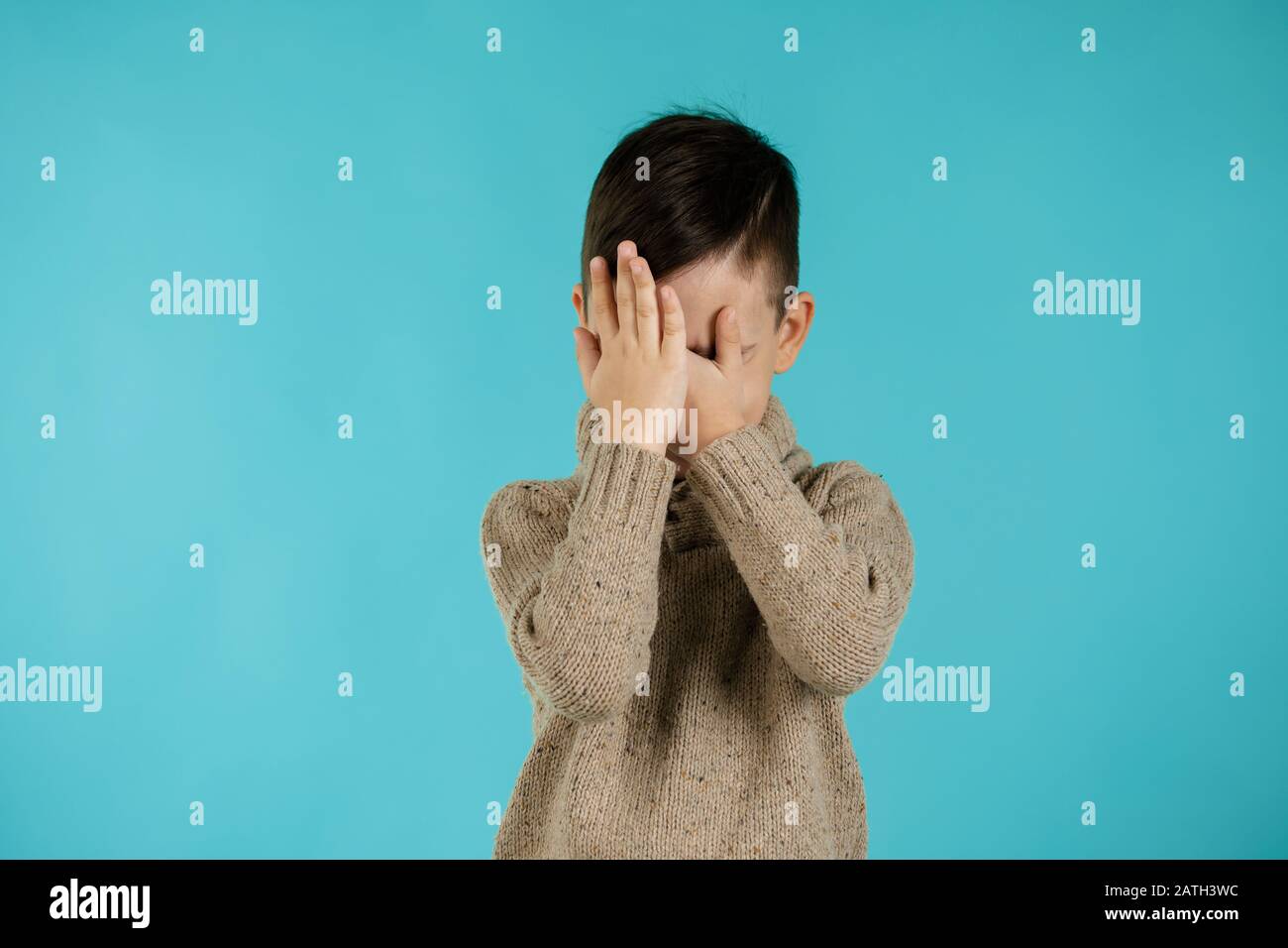 sad little child boy on blue background. Human emotions and facial ...