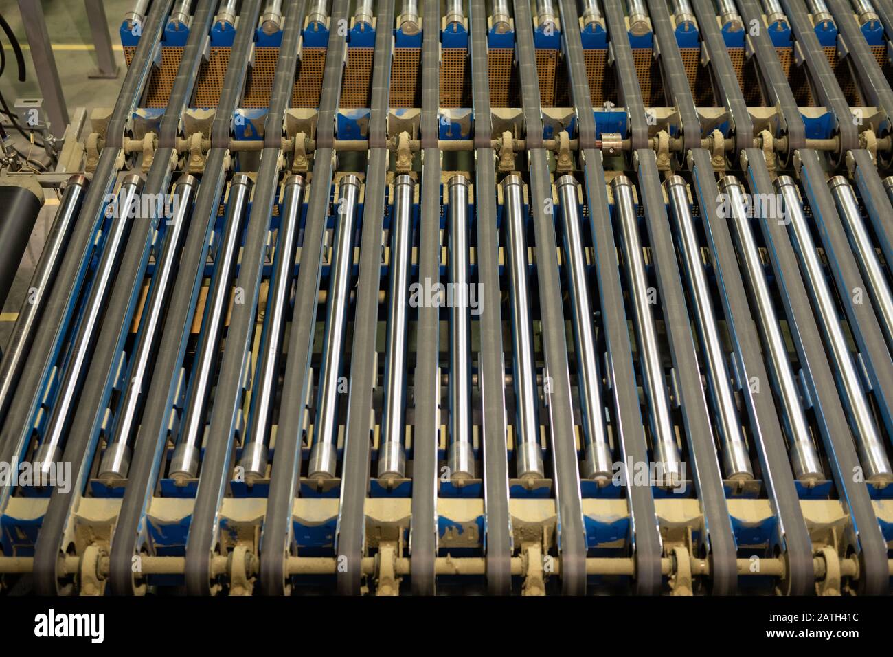 Conveyor belt background: above view of rotating pipes used for ...