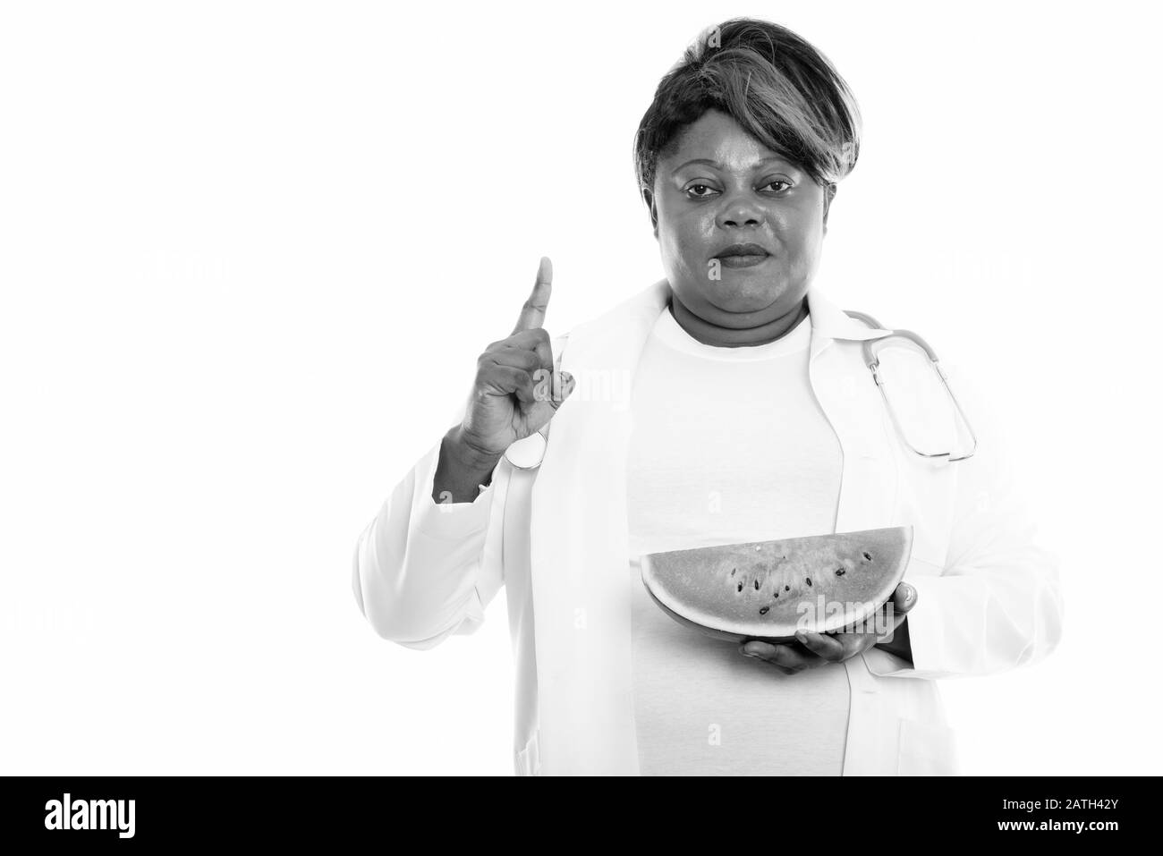 Studio shot of fat black African woman doctor holding slice of ...