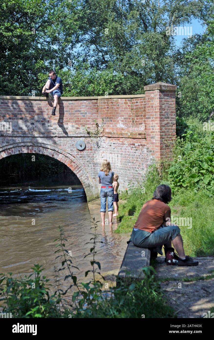 family beside river waveney geldeston norfolk england Stock Photo - Alamy