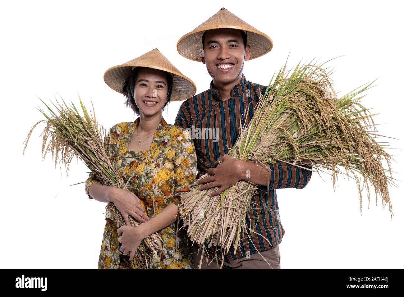 traditional male and female asian farmer with rice paddy grain in hand ...