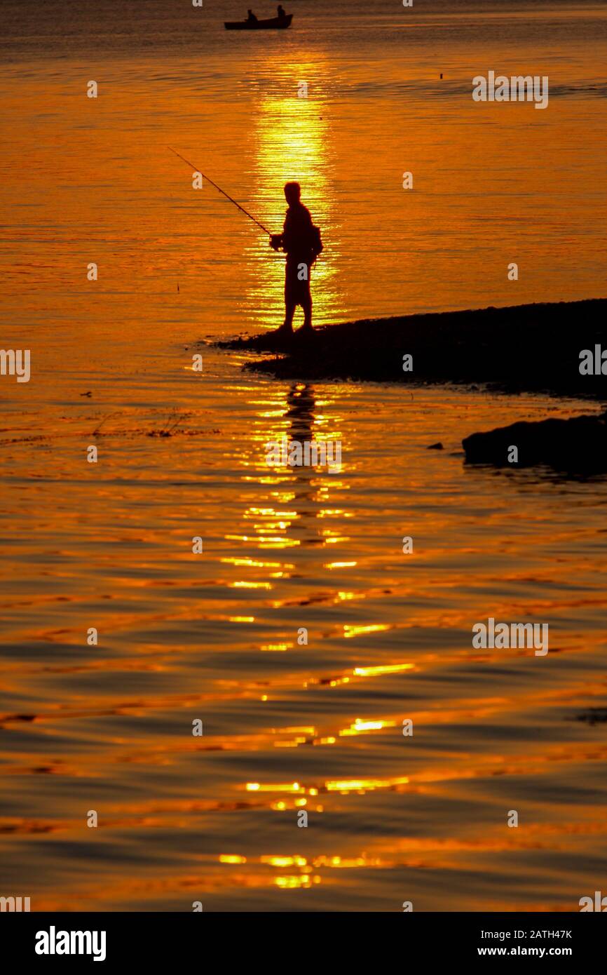 Fishing at lake Modrac during sunset, near Tuzla, Bosnia Stock Photo ...