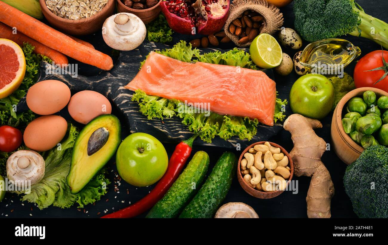 Healthy food. Fish salmon, avocado, broccoli, fresh vegetables, nuts ...