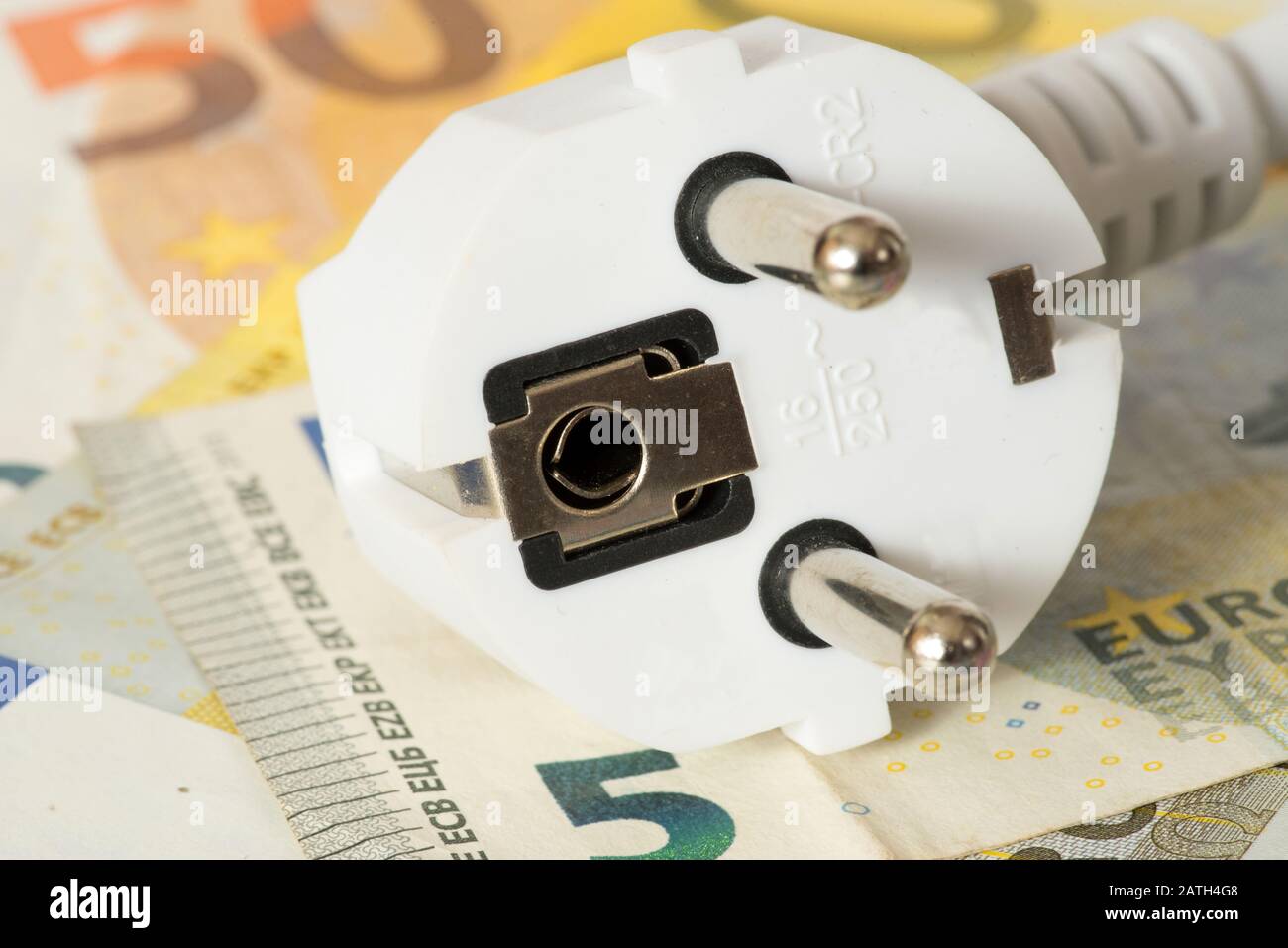 Electric plug and euro banknotes Stock Photo - Alamy