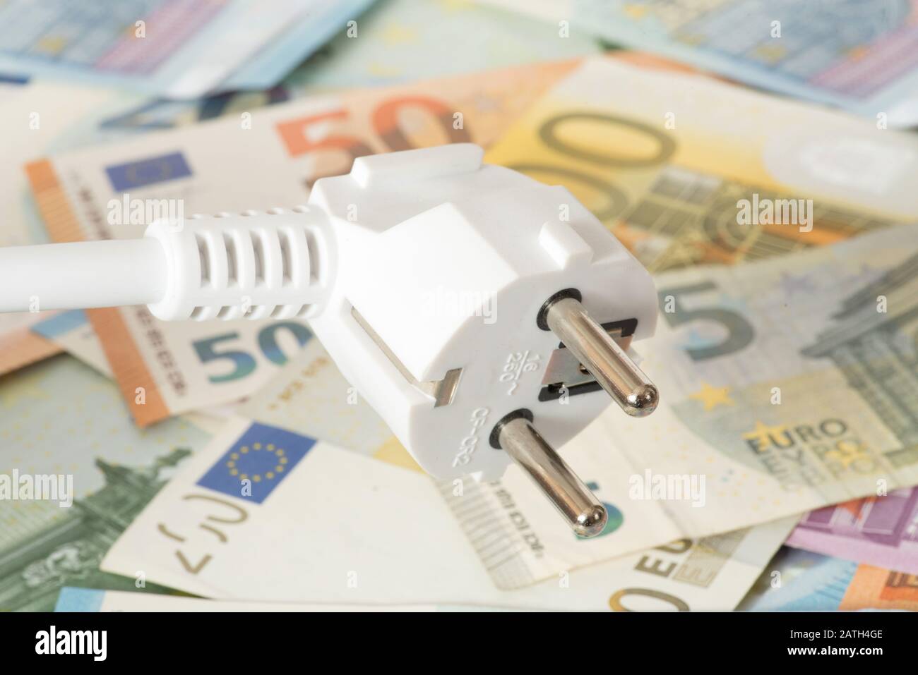 Electric plug and euro banknotes Stock Photo - Alamy